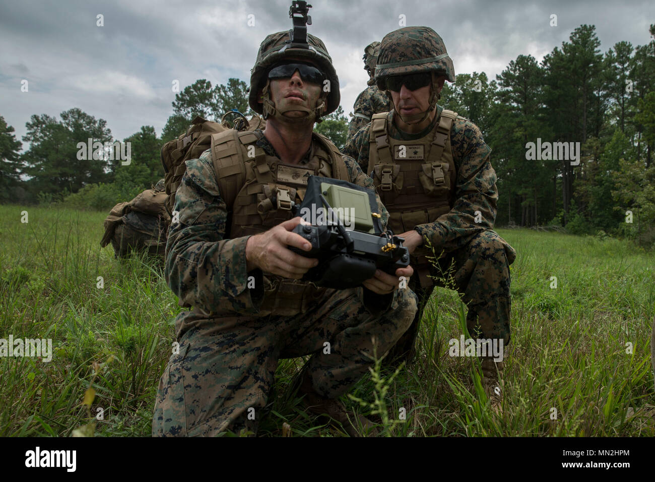 U.S. Marine Corps Lance Cpl. Ryan Skinner (center), assistant patrol ...