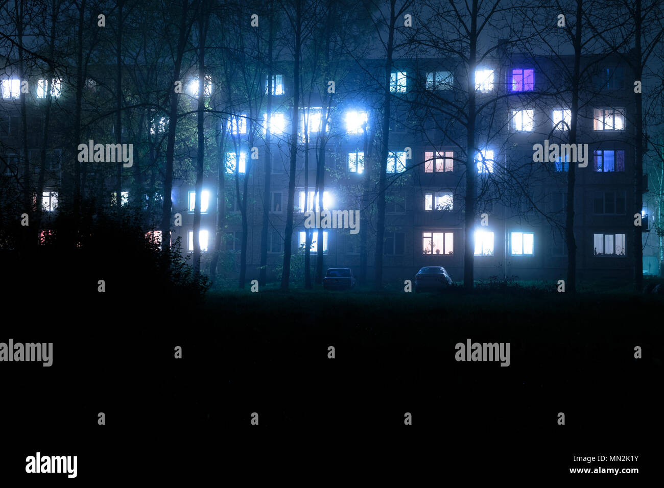 windows of a multi storey building at night Stock Photo - Alamy