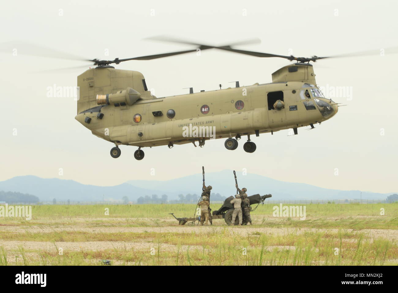 Spc. Simon Daravong, a CH-47 Chinook helicopter flight engineer, leans ...