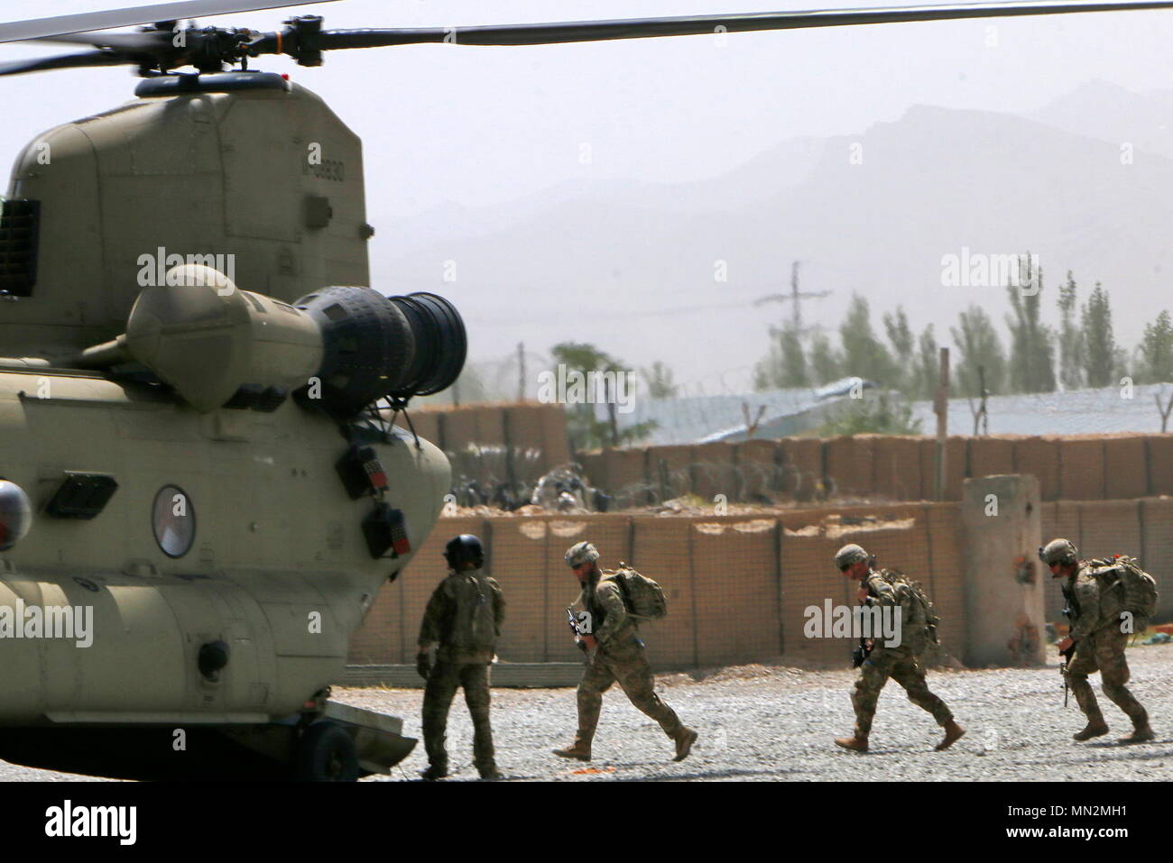 U.S. Army Soldiers from Task Force Southeast load onto a helicopter to ...
