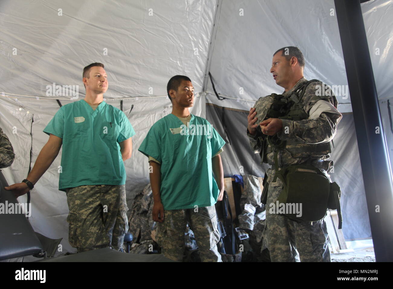 U.S. Army Lt. Col. Evan Hart, right, assigned to 143rd Dental ...