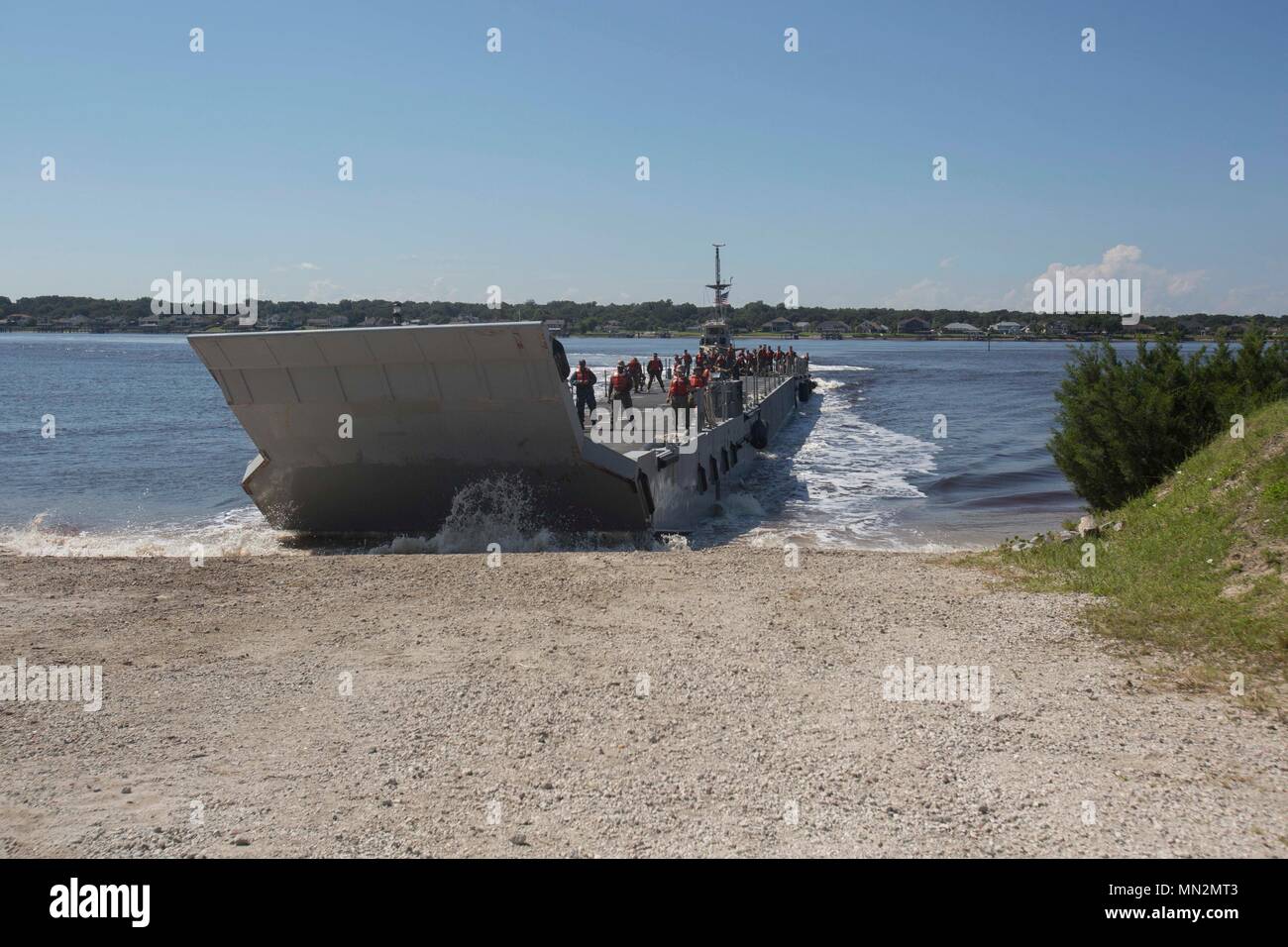 A naval landing craft prepares to land on the beach to offload Marines ...