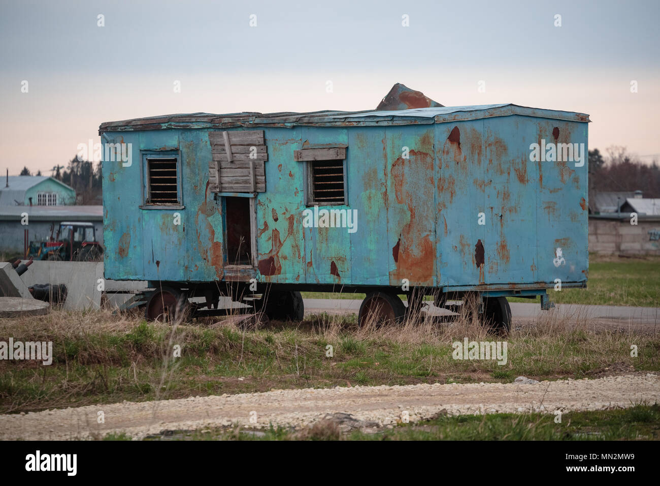 blue and rusty cabins in the field Stock Photo - Alamy