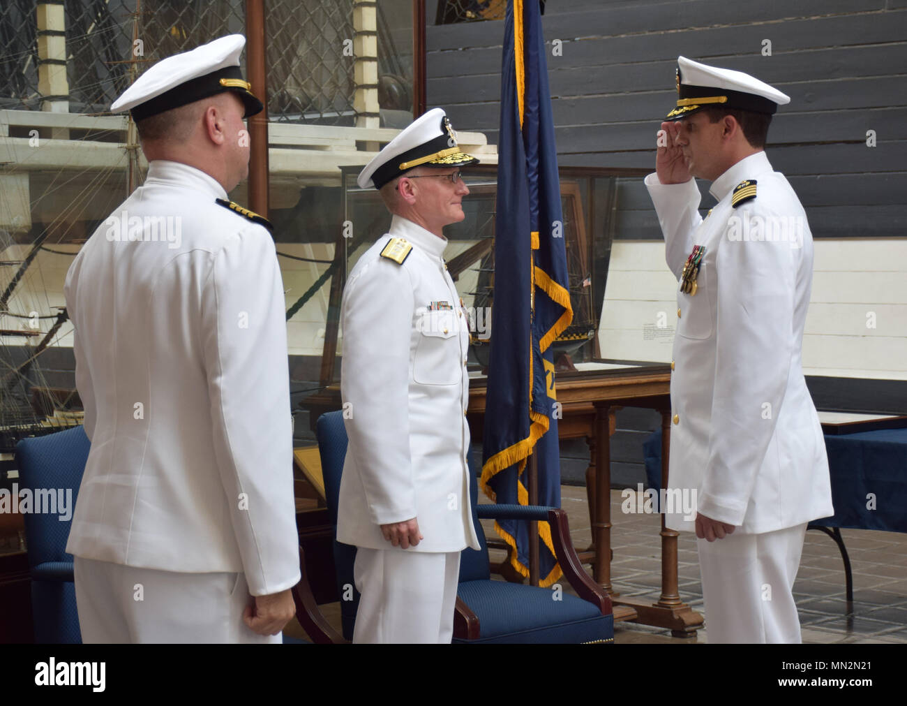 Capt. Bruce A. Gragert, right, salutes Rear Adm. John Hannink ...