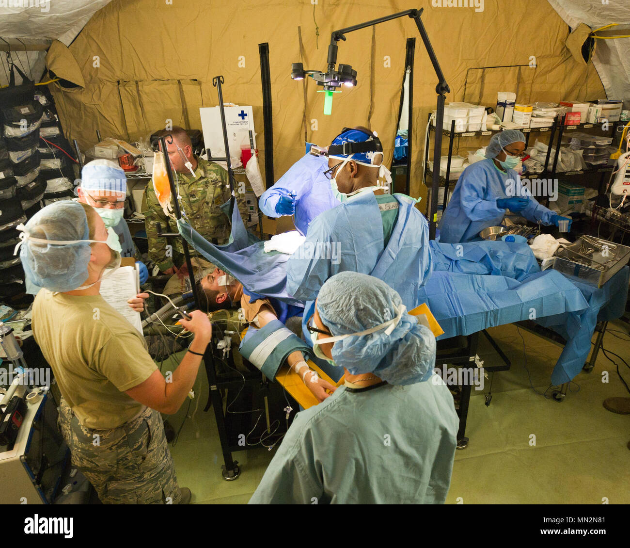 A U.S. Air Force surgical team performs surgery on the human worn ...