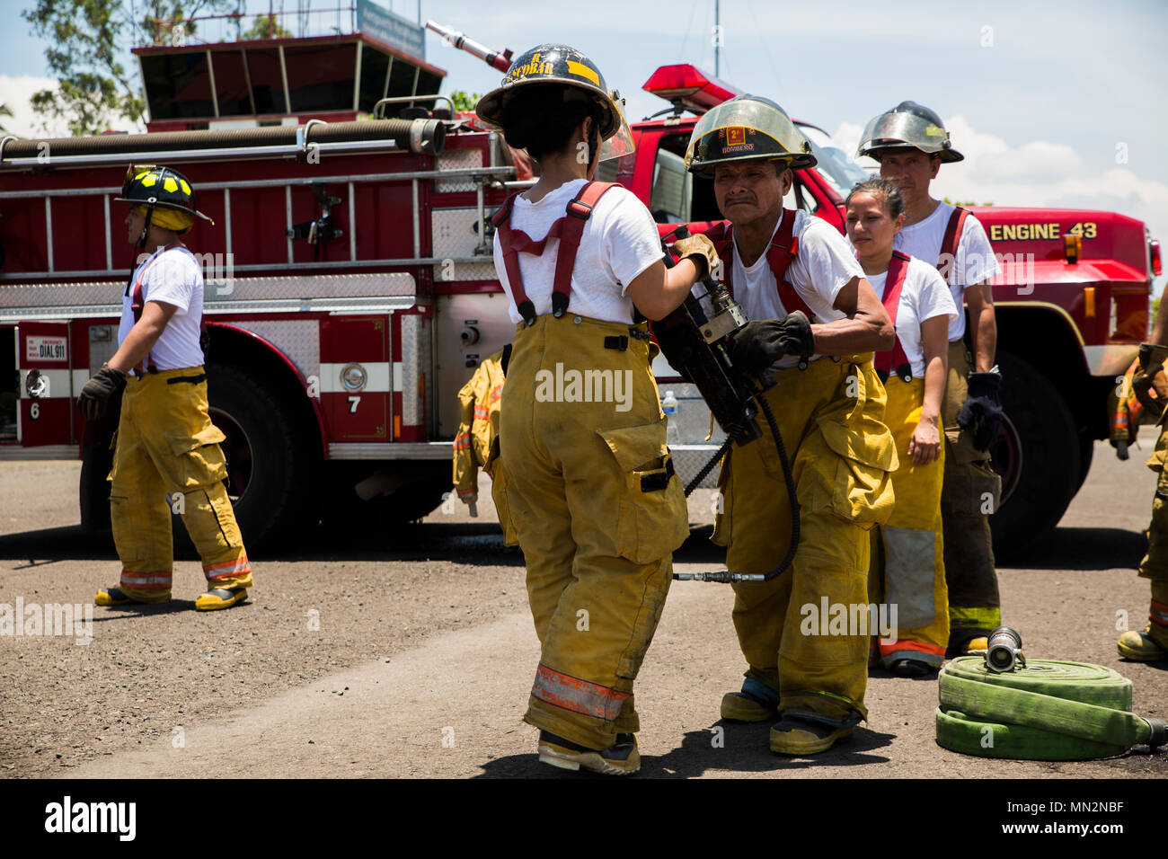 Firefighters with the Retalhuleu Fire Department pass equipment to each ...