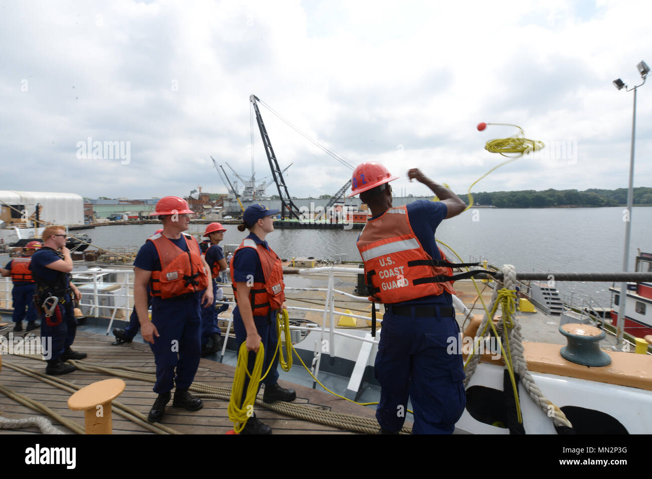 Damage Controlman 2nd Class Chris Stevenson heaves a messenger line as ...