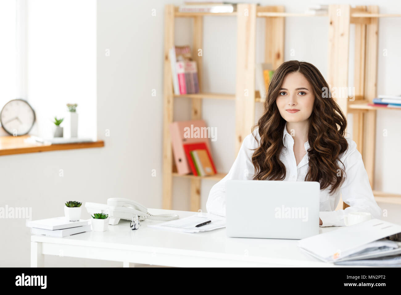Young pretty business woman with notebook and document in the bright ...