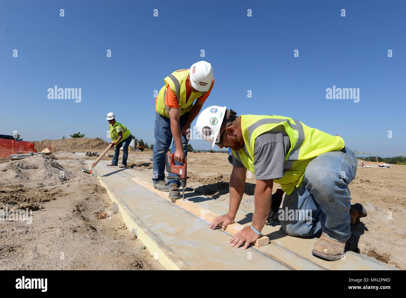 Carpenters with the LS Black Constructors Company work on a stem wall ...