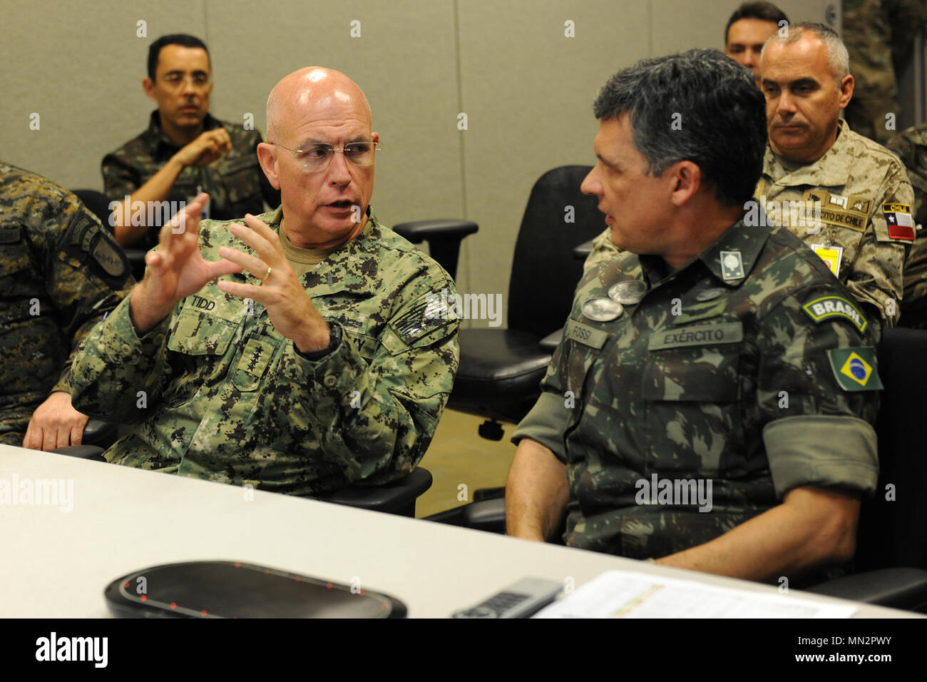 Adm. Kurt Tidd (left), commander of U.S. Southern Command, visits with ...