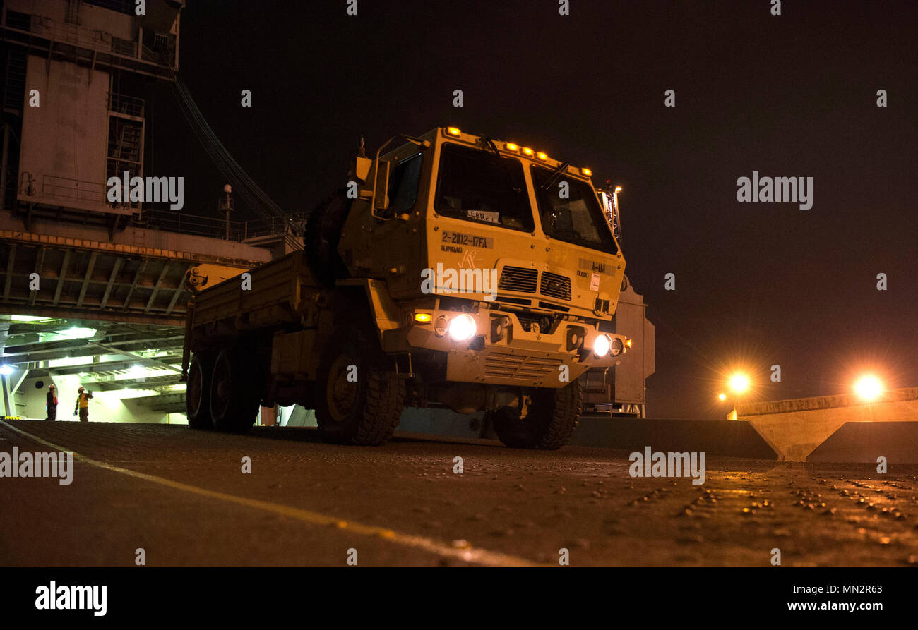 An armored vehicle exits the USS Cape Isabel at the Port of San Diego ...