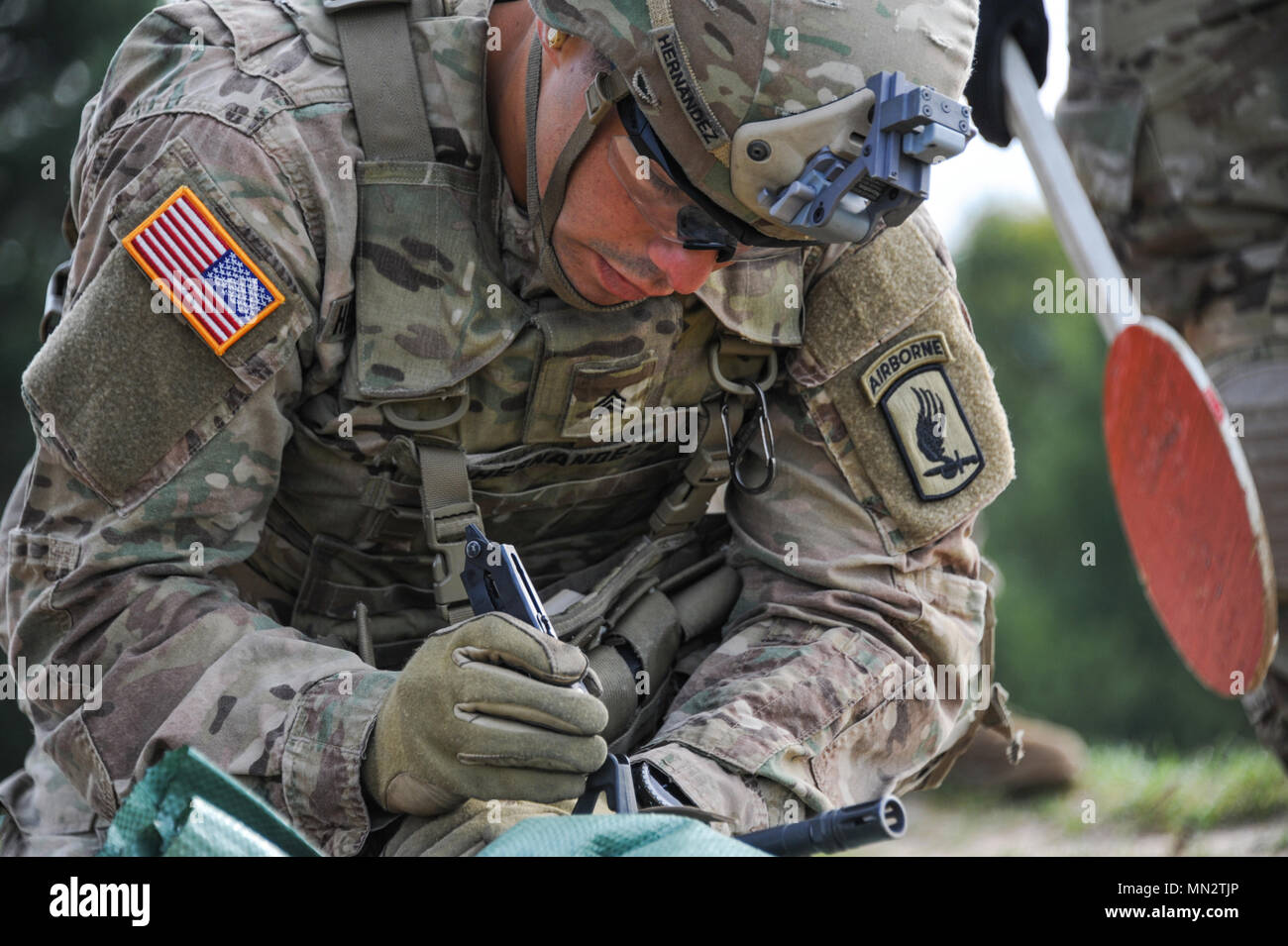 U.S. Army Sgt. Antonio Hernandez with 173rd Airborne Brigade adjusts ...