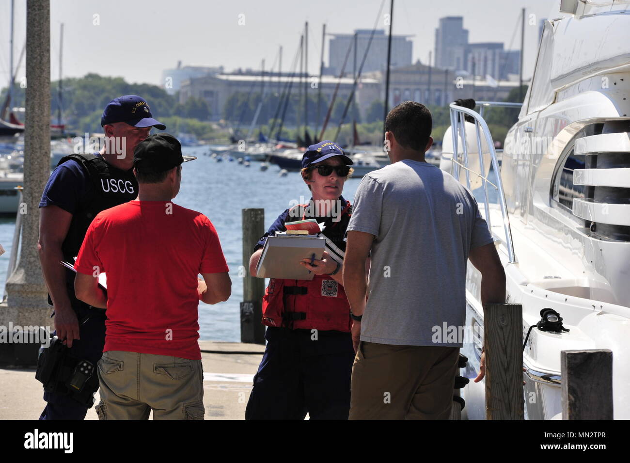 Members of the U.S. Coast Guard verify proper documentation and ...