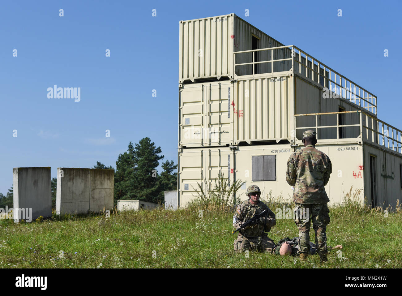 U.S. Army Chief Warrant Officer 2 Kristopher Gillespie, kneeling, with ...