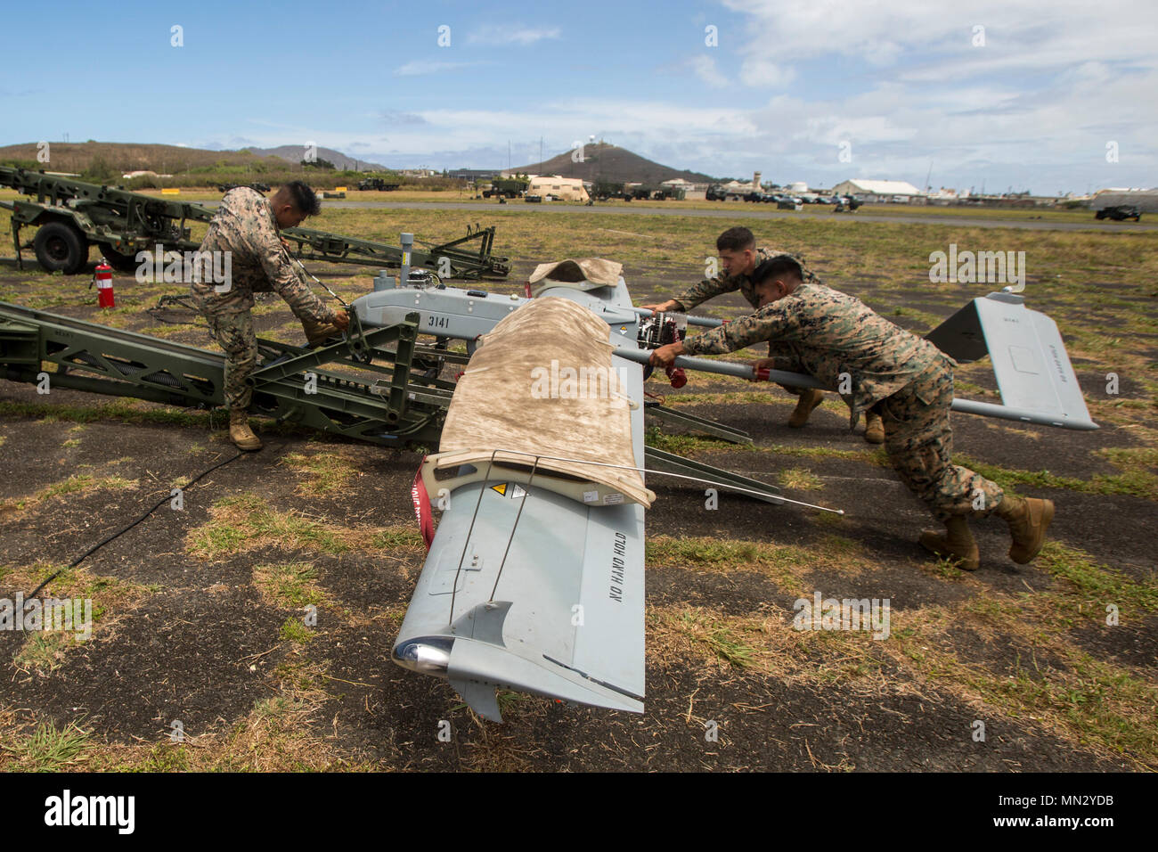 U.S. Marines with Marine Unmanned Vehicle Squadron 3, push an RQ-7B ...