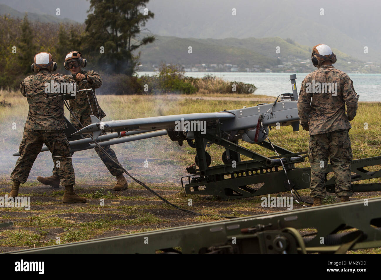 U.S. Marines with Marine Unmanned Vehicle Squadron 3, start the engine ...