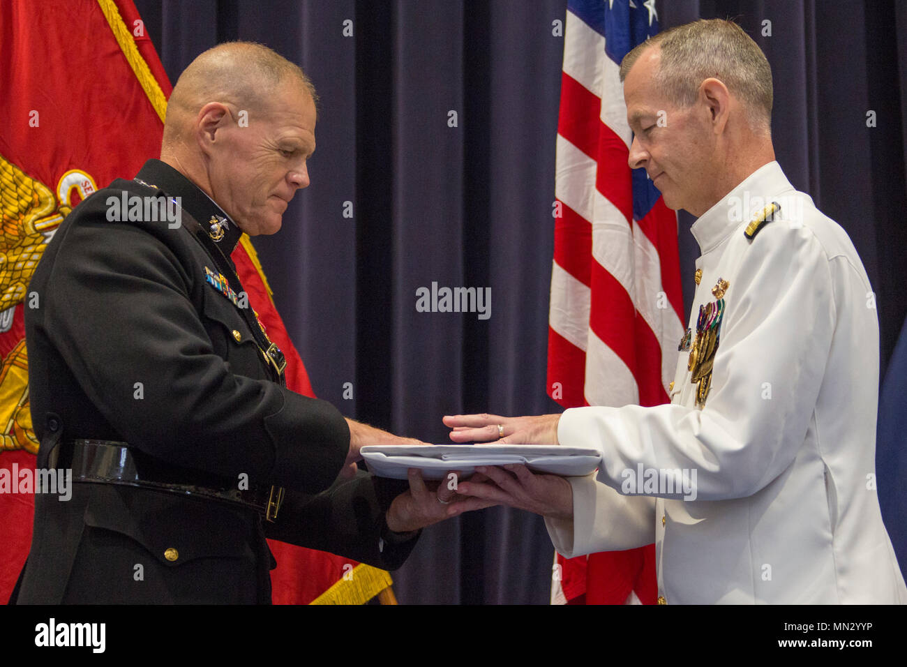 Commandant of the Marine Corps Gen. Robert B. Neller, left, presents a ...
