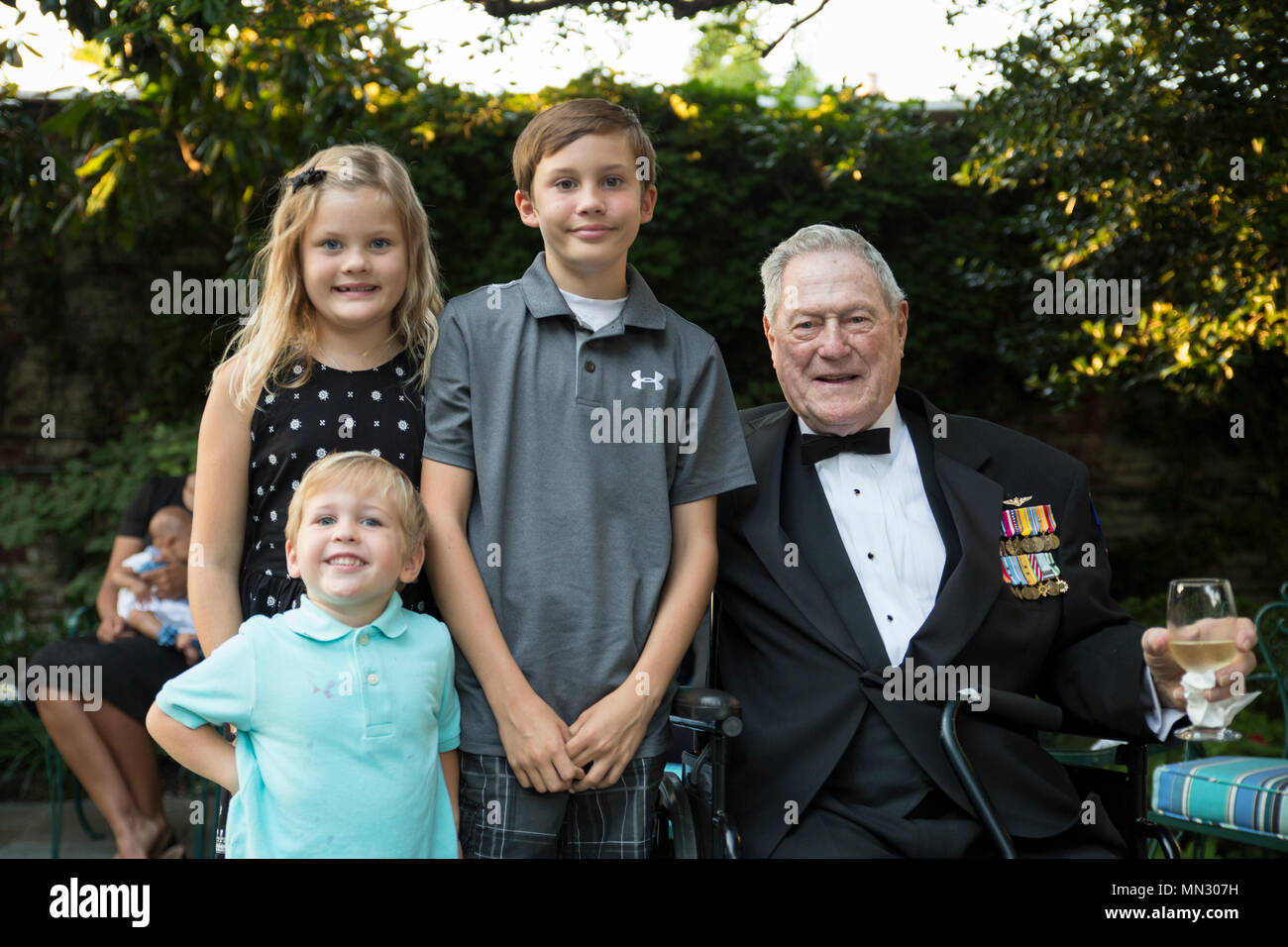 World War II veteran Col. Archie “Hap” Simpson poses with guests at a ...