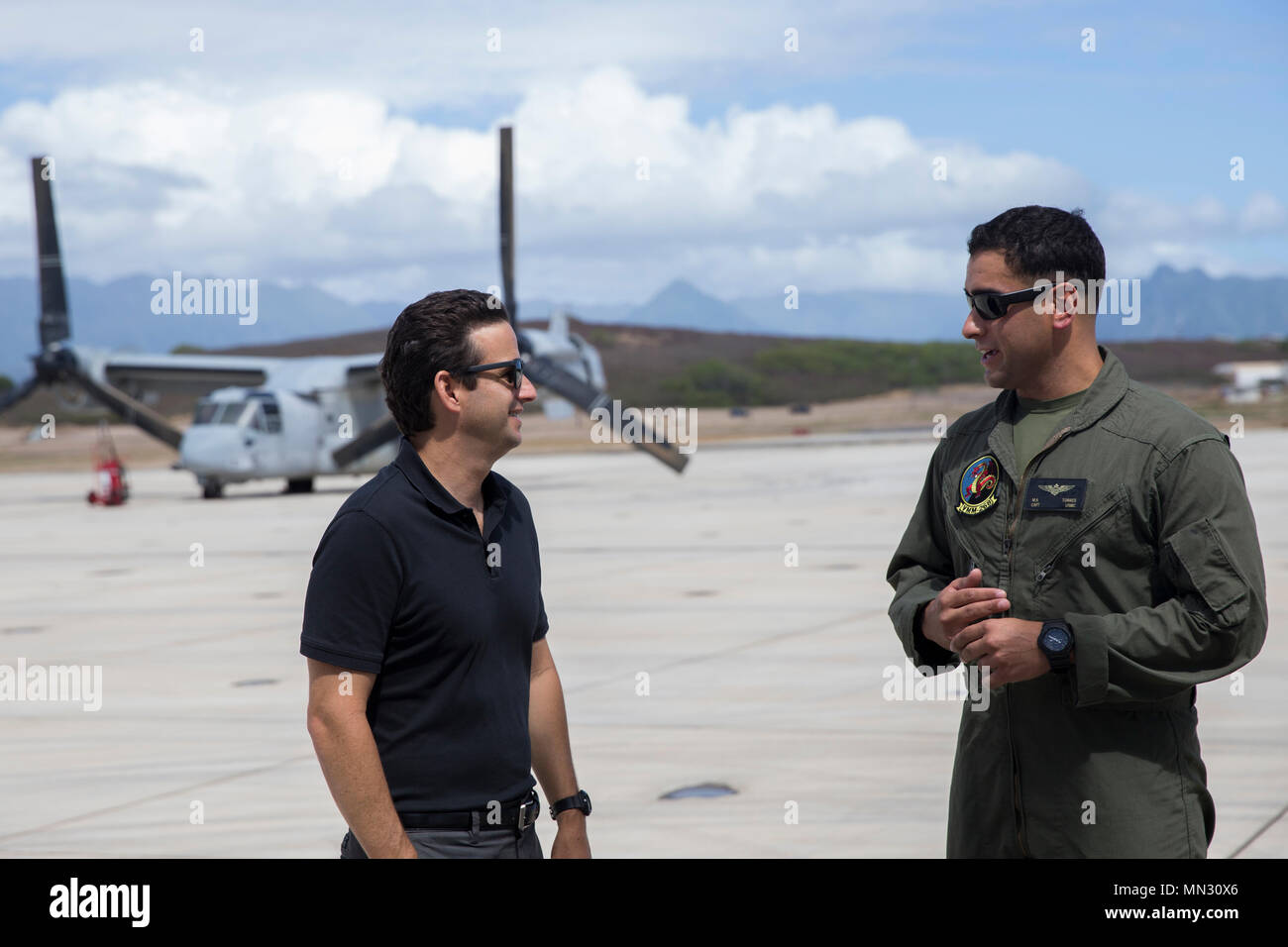 U.S. Senator Brian Schatz of Hawaii, speaks with Capt. Manuel Torres ...