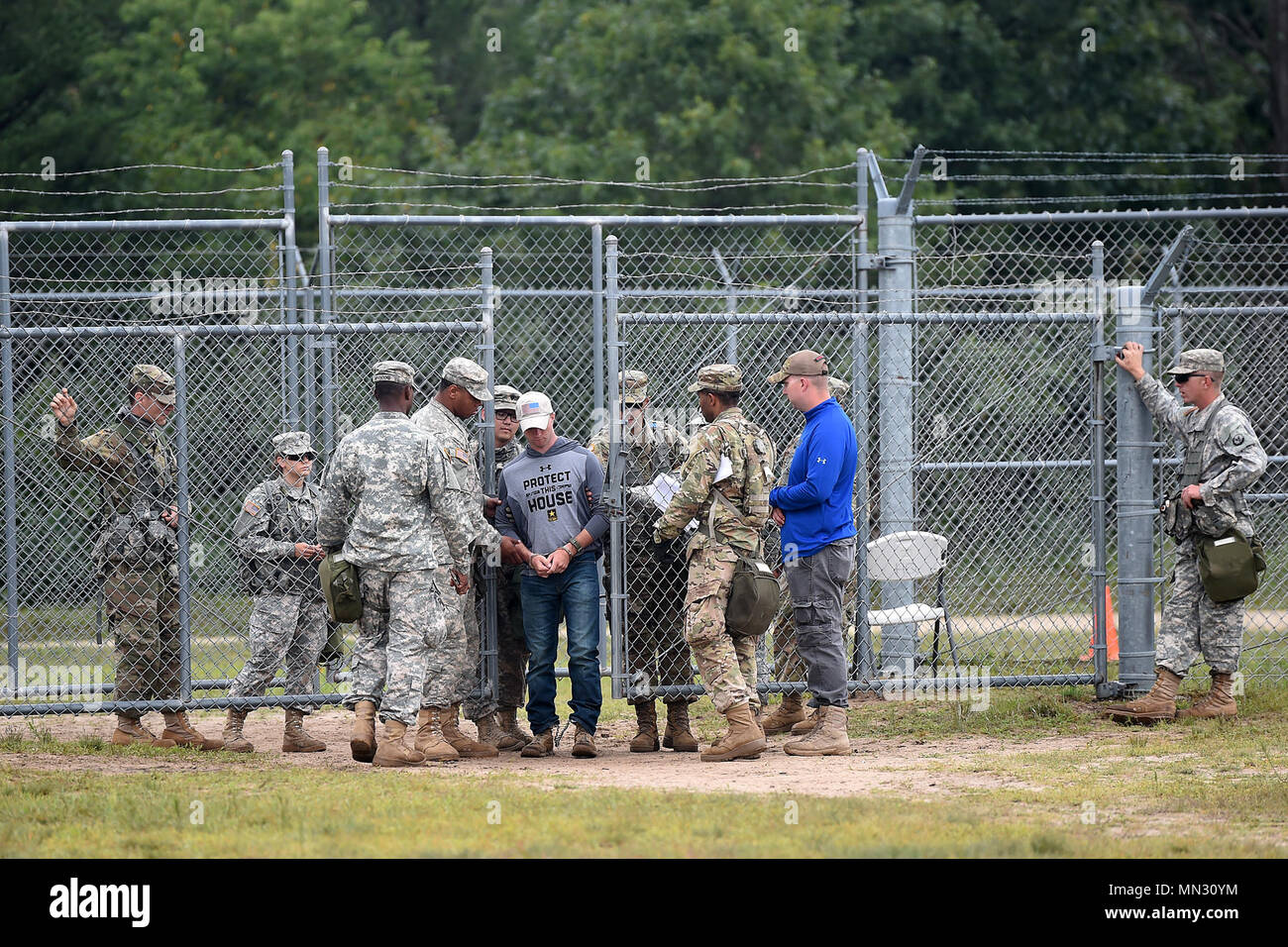 Army Reserve Military Police in-process a detainee at an entry control ...