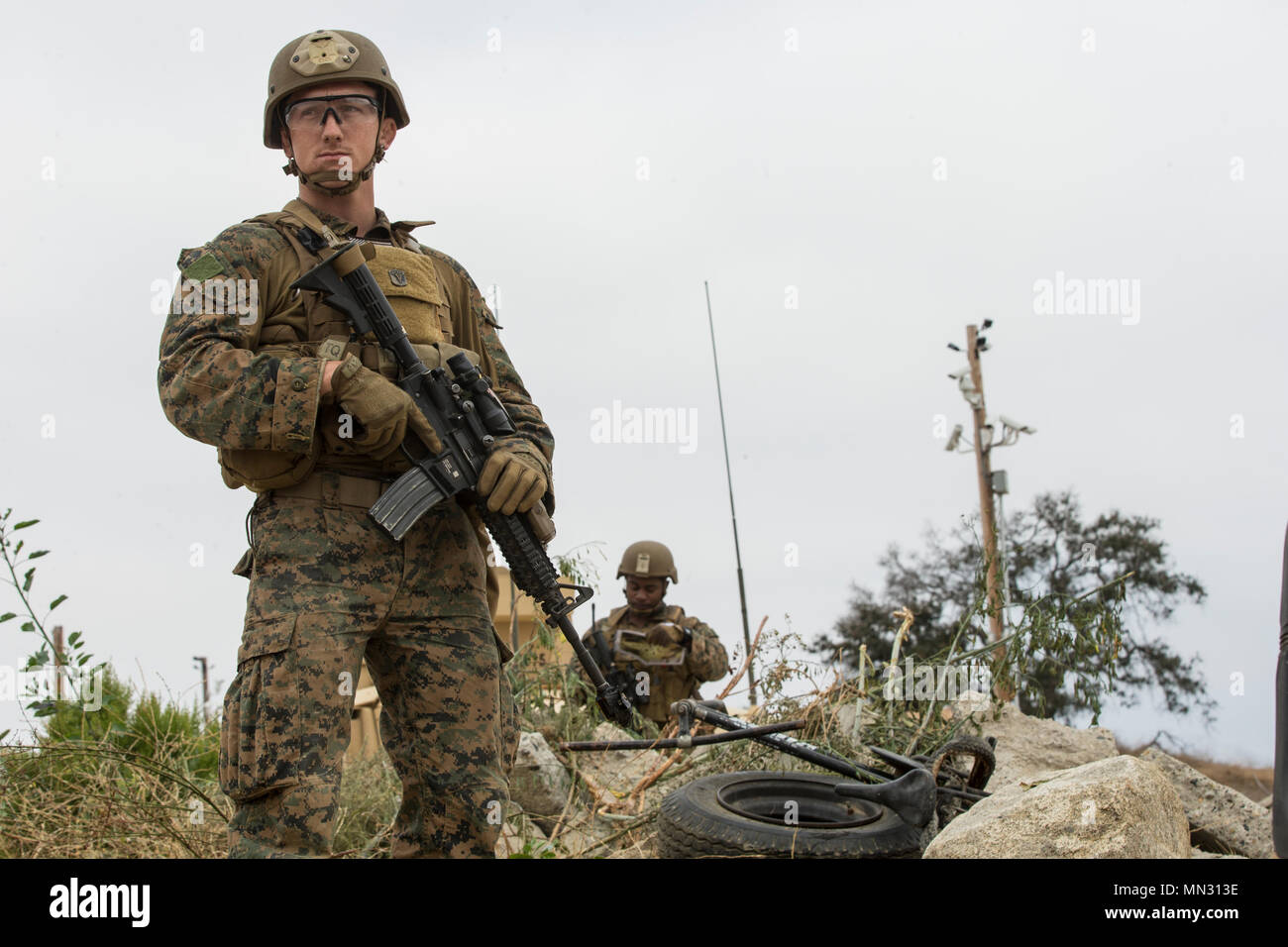 U.S. Navy HM3 Matthew Welch, a Corpsman, watches over his fire team as ...