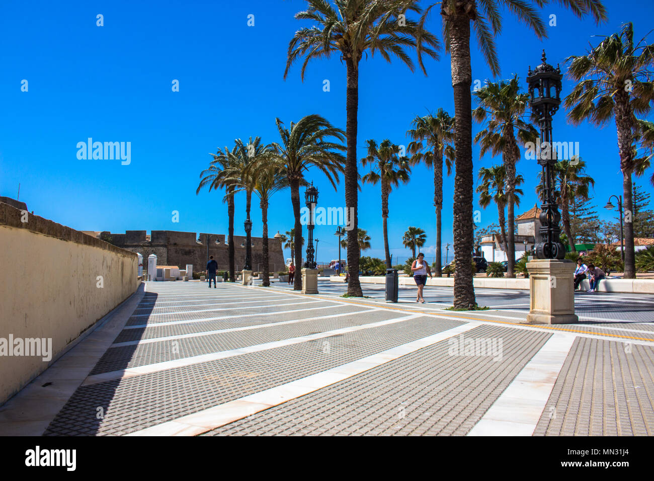 Promenade. A sunny day on the beach of Cadiz. Andalusia, Spain. Picture ...