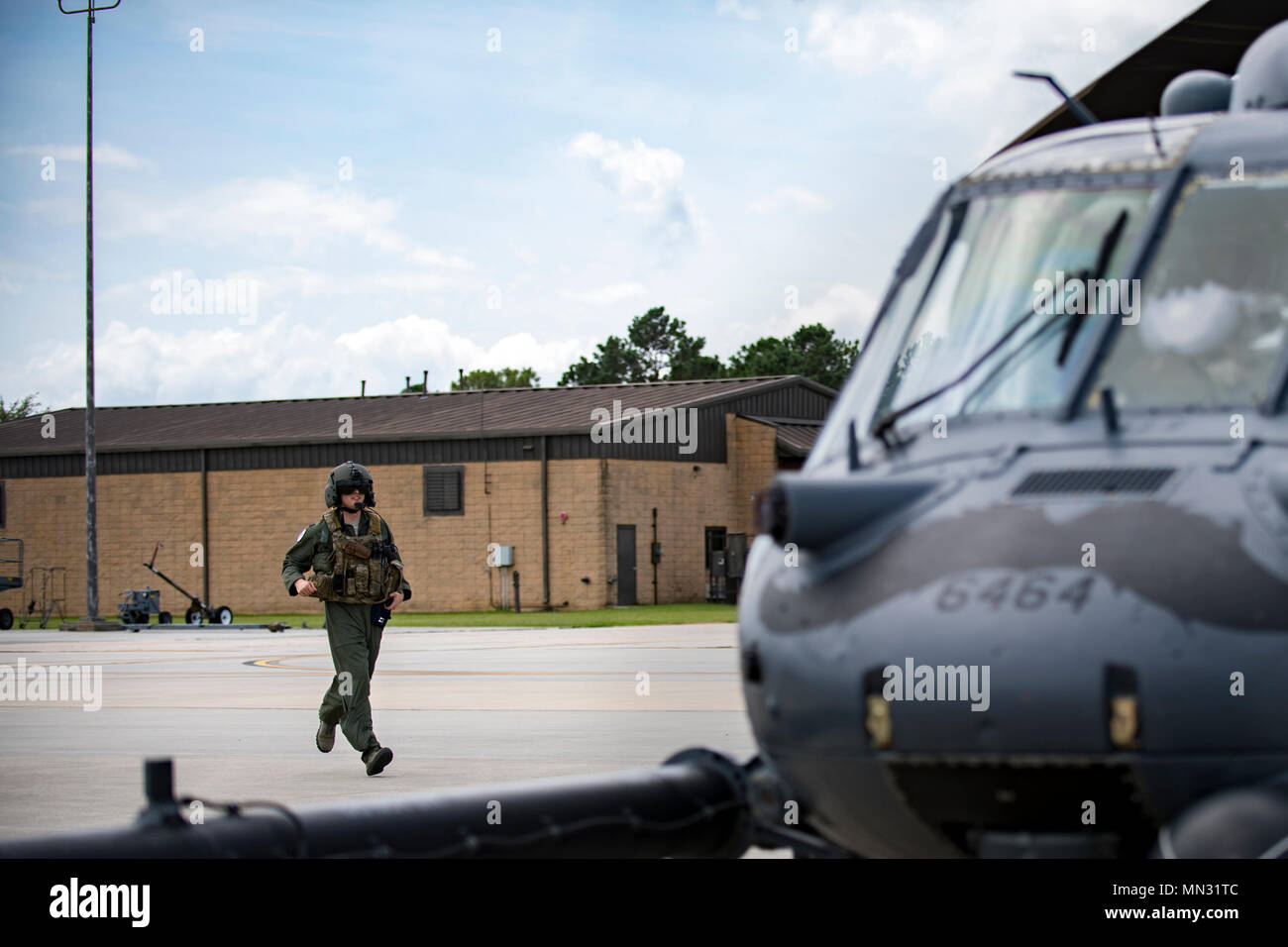 A U.S. Air Force 41st Rescue Squadron crew member hurries to an HH-60G ...