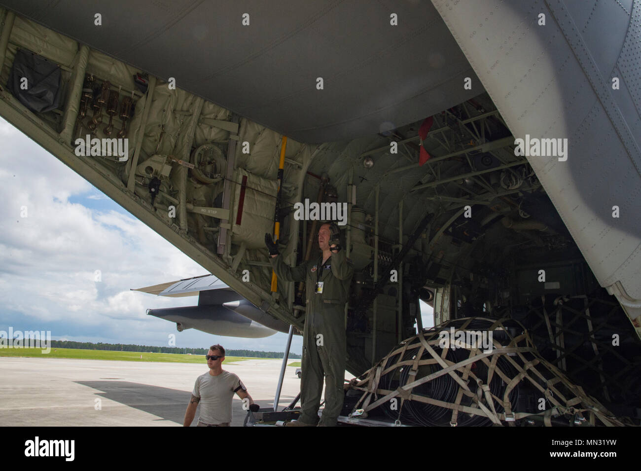 A U.S. Air Force loadmaster from the 71st Rescue Squadron guides a ...