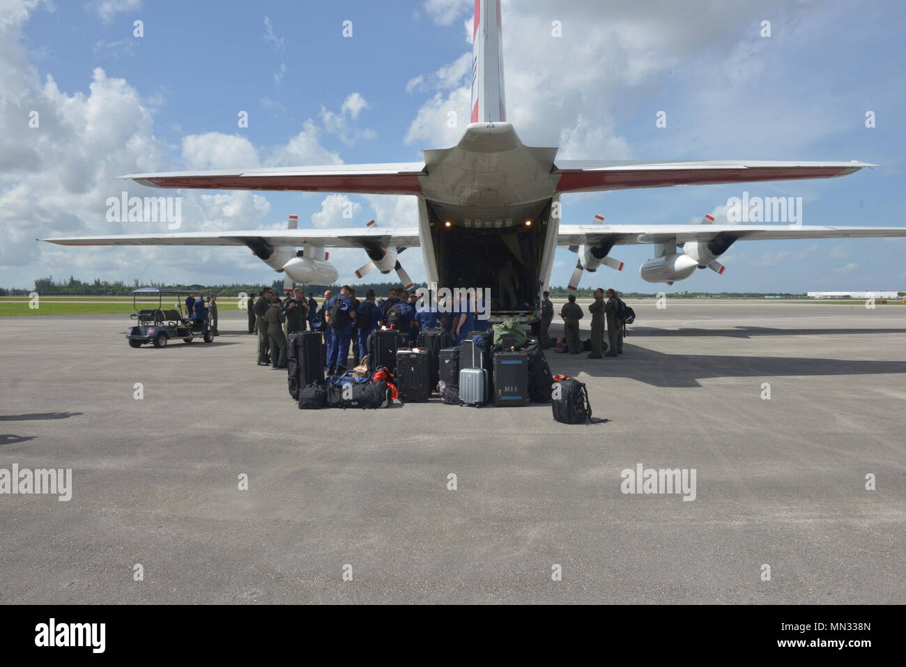 Members of Miami-based Coast Guard crews standby as their bags are ...