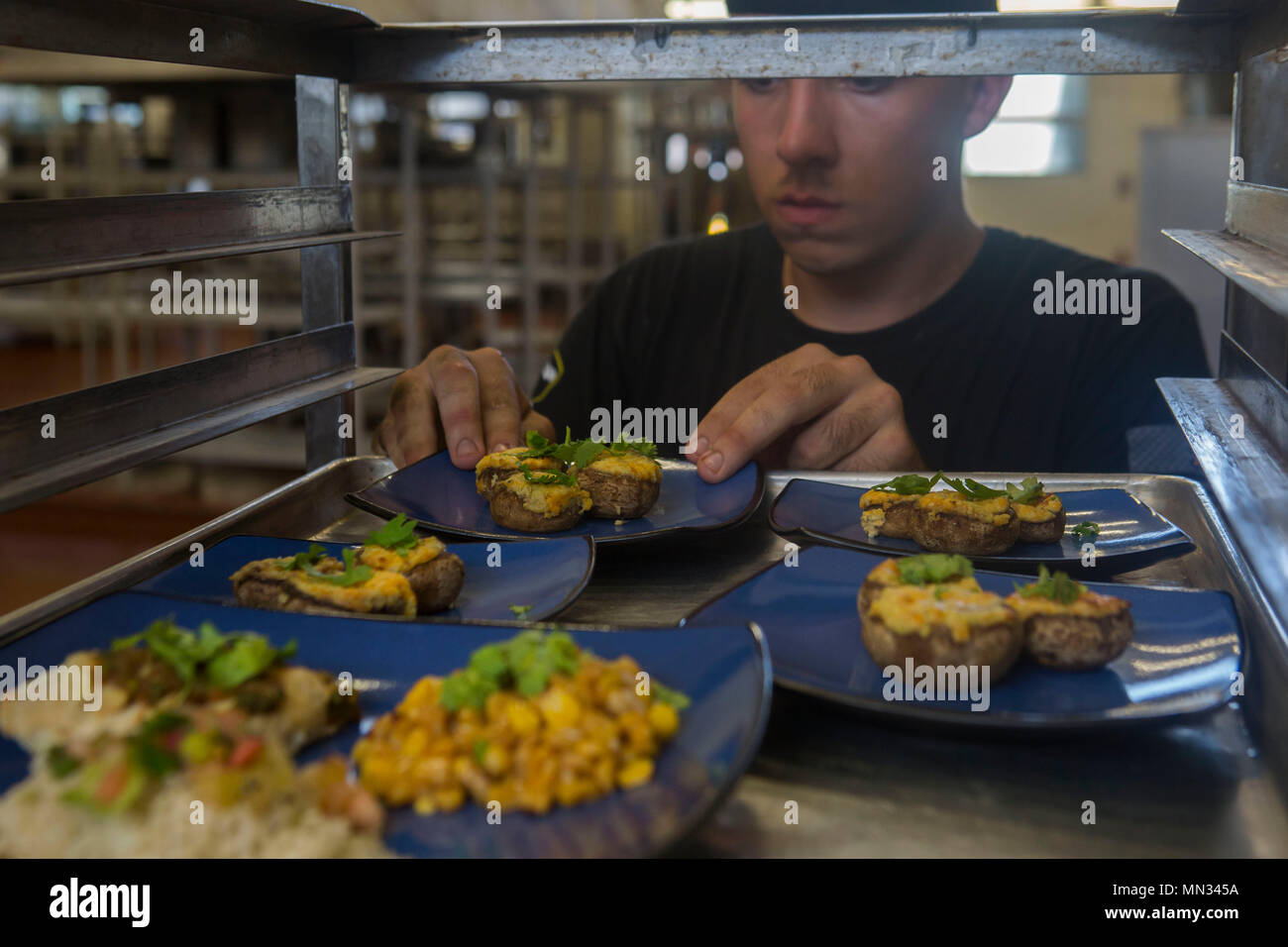 U.S. Marine Corps Lance Cpl. Bryan Carter, a food service specialist ...