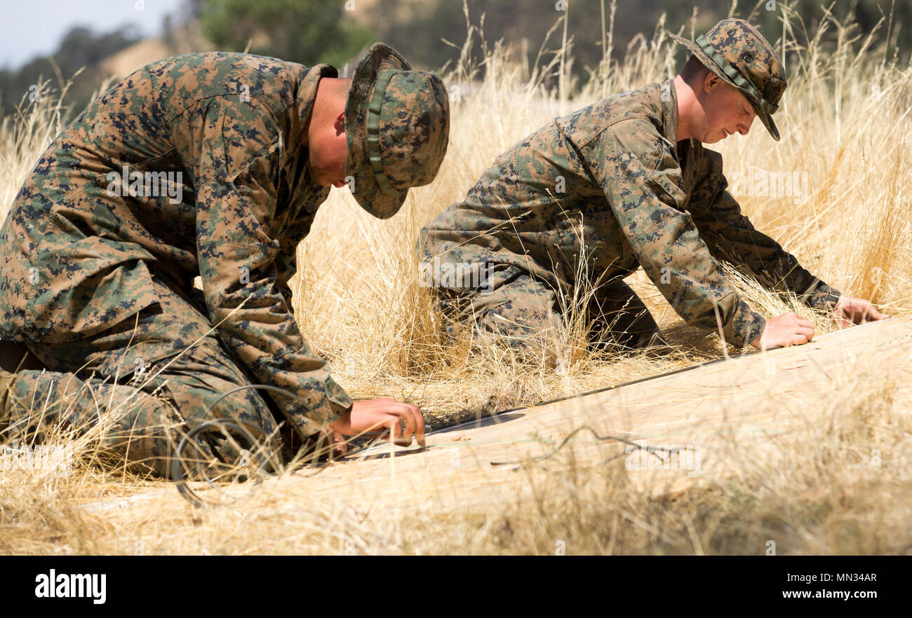 U.S. Marines with 1st Combat Engineer Battalion (CEB), measure a fuse ...