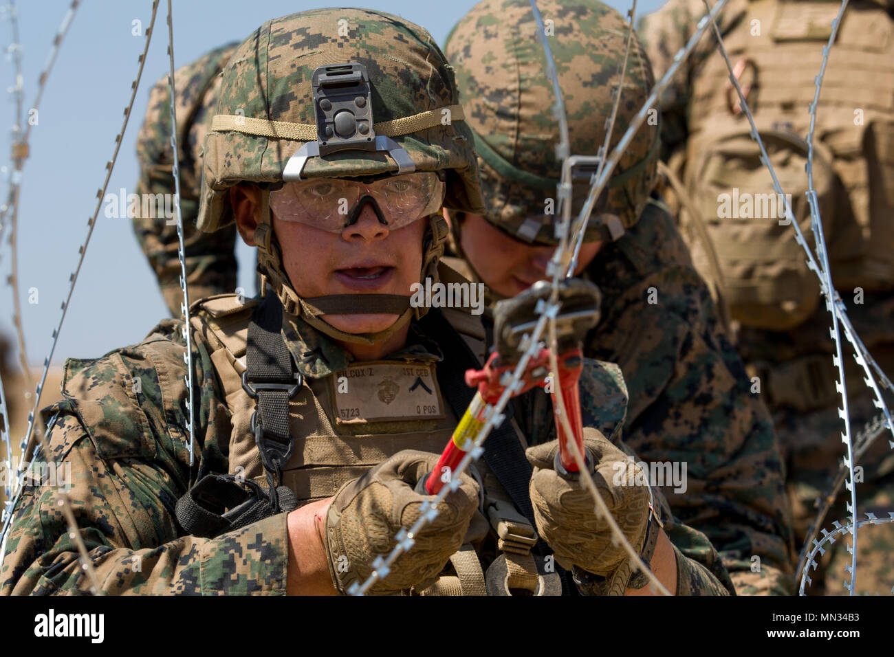 A U.S. Marine with 1st Combat Engineer Battalion (CEB) cuts concertina ...