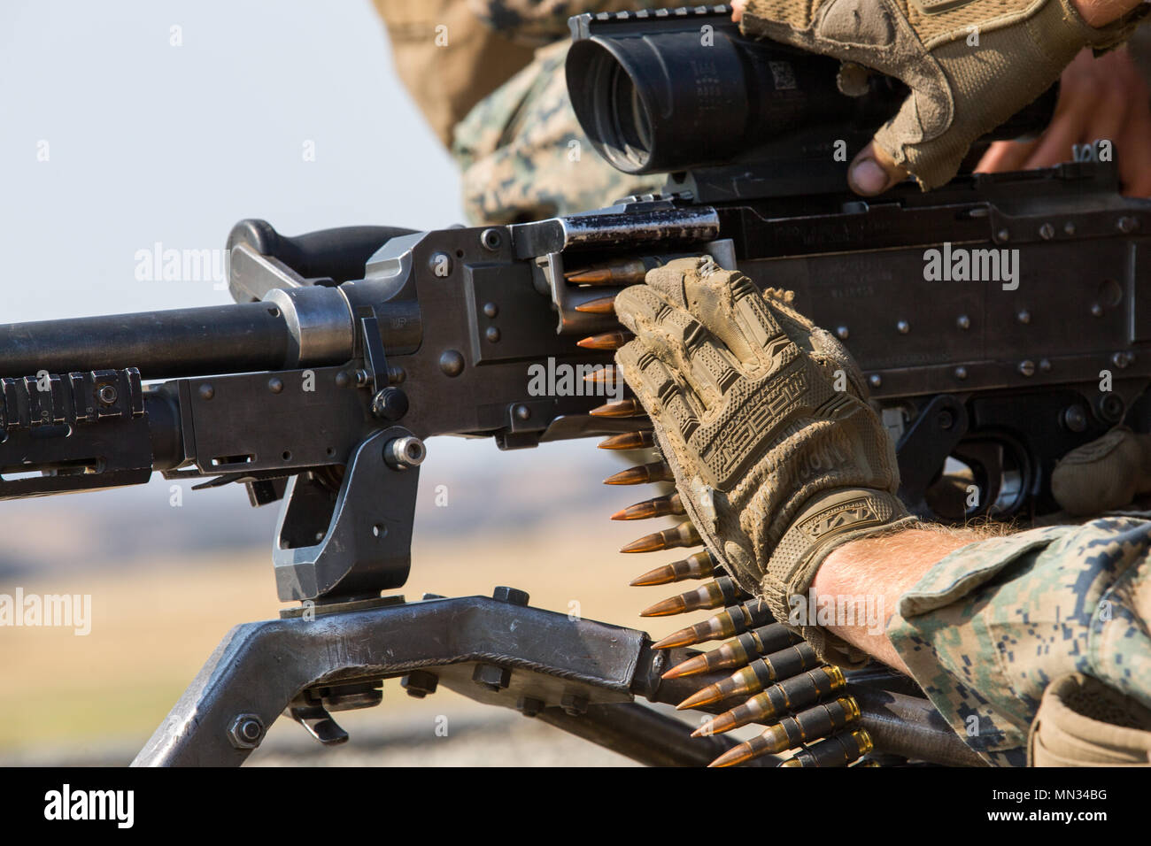 A U.S. Marine with 1st Combat Engineer Battalion (CEB) loads rounds ...