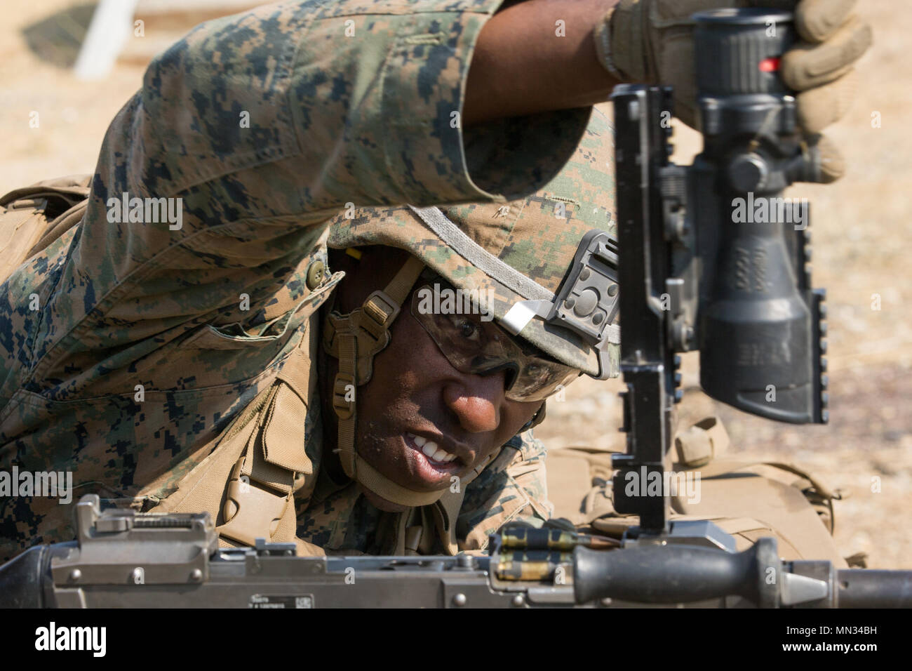 A U.S. Marine with 1st Combat Engineer Battalion (CEB) loads rounds ...