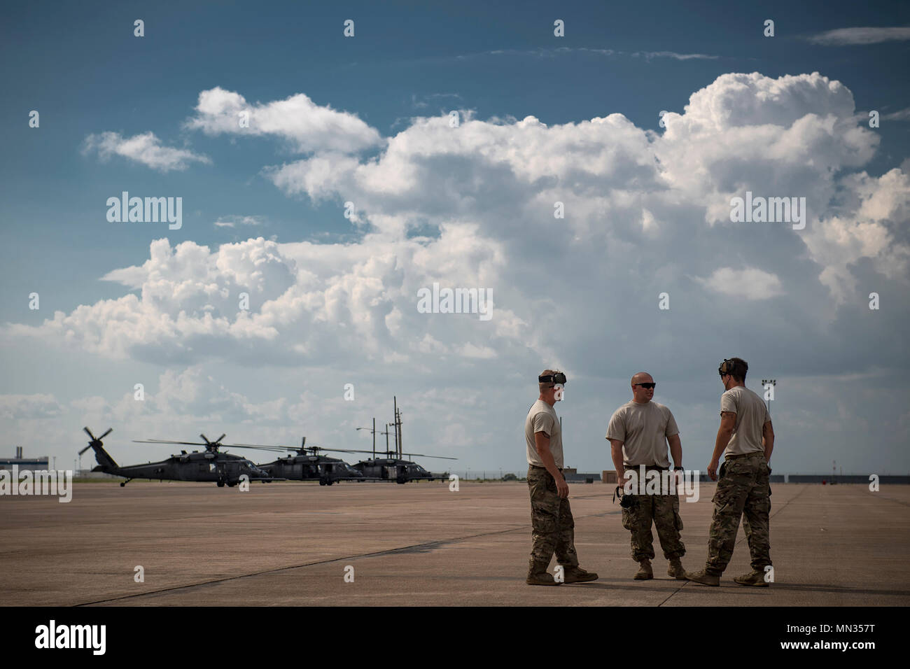 Maintainers from the 41st Helicopter Maintenance Unit huddle on the ...