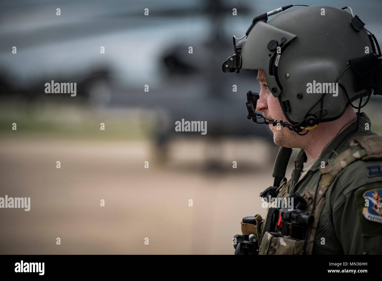 An HH-60G Pave Hawk pilot from the 41st Rescue Squadron walks across ...