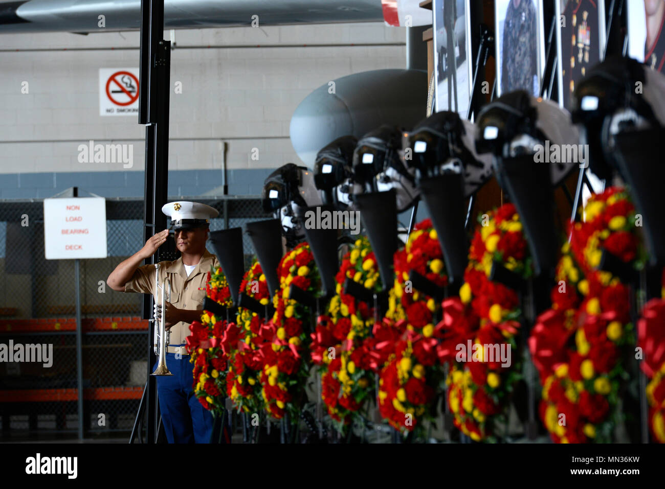 A U.S. Marine Corps bugle player salutes after playing taps during a ...