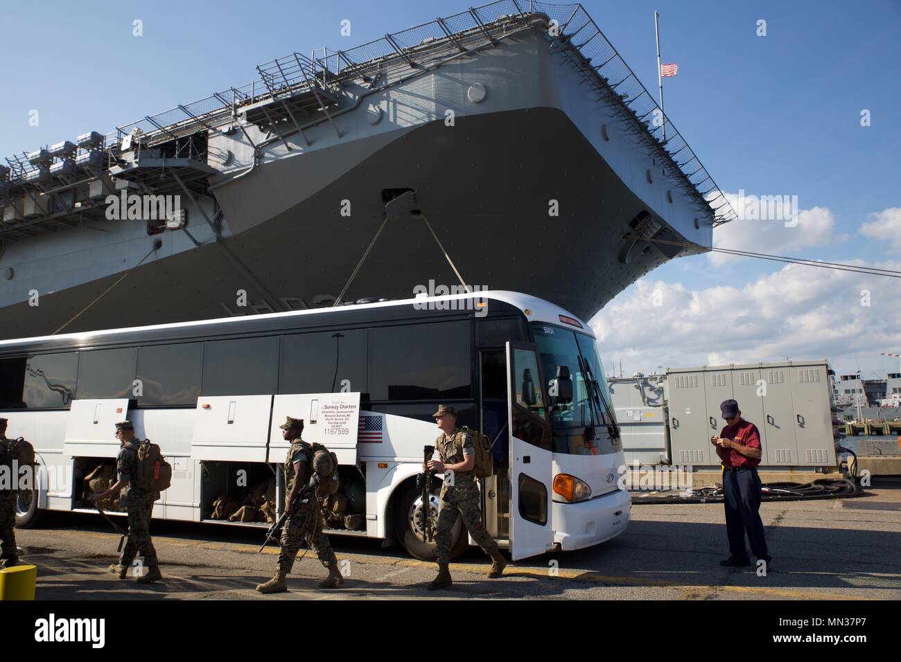 Members of the 26th Marine Expeditionary Unit get off their buses and ...