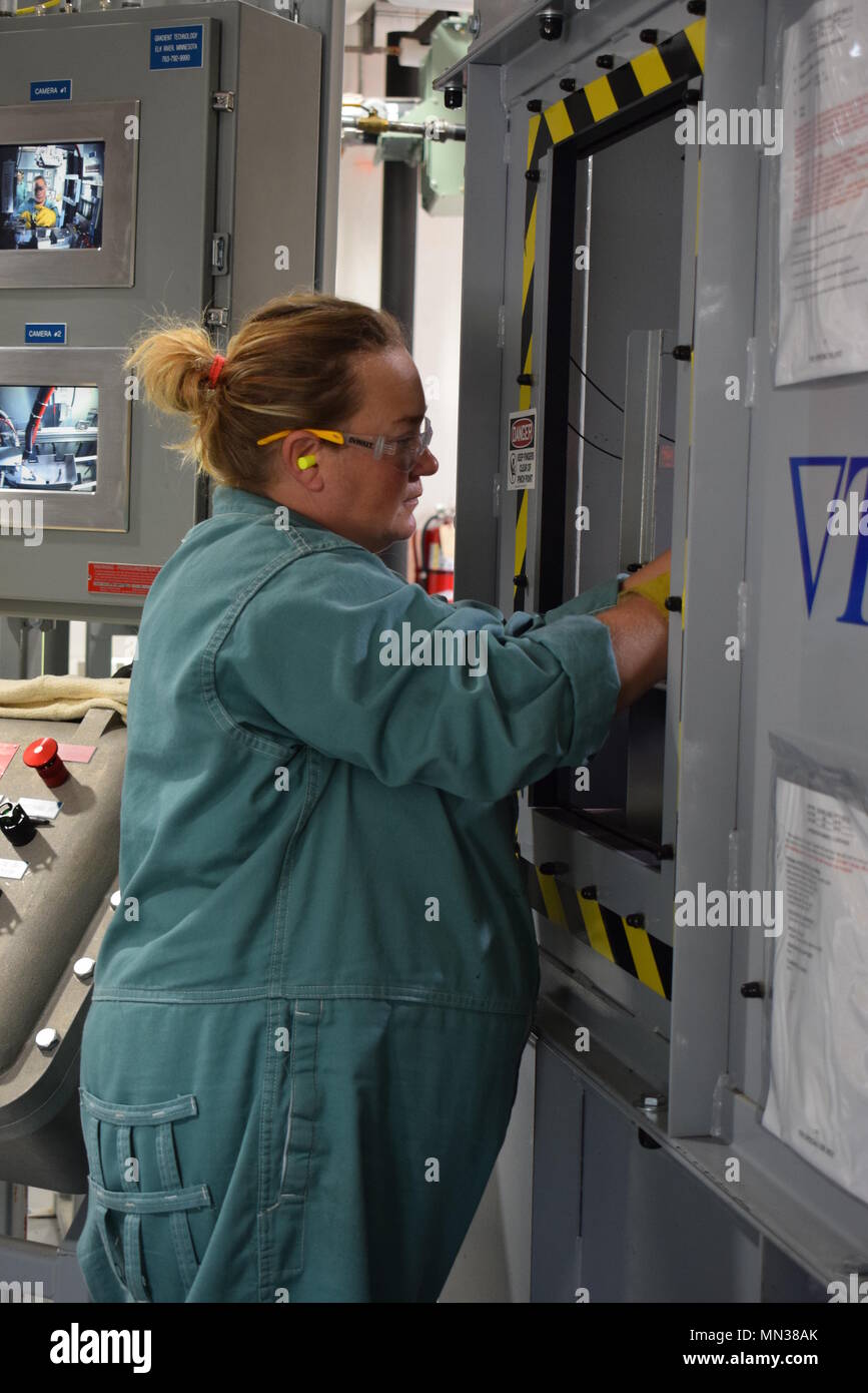 A Crane Army employee places an L8A3 smoke grenade into the modular ...