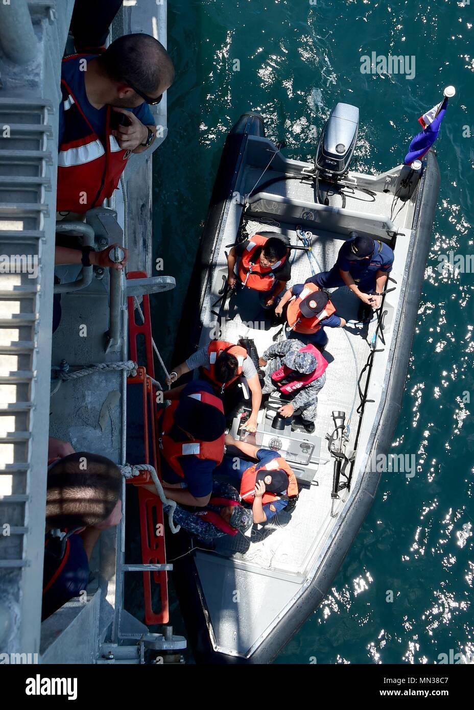 Members of the Philippine Coast Guard Special Operations Group climb a ...