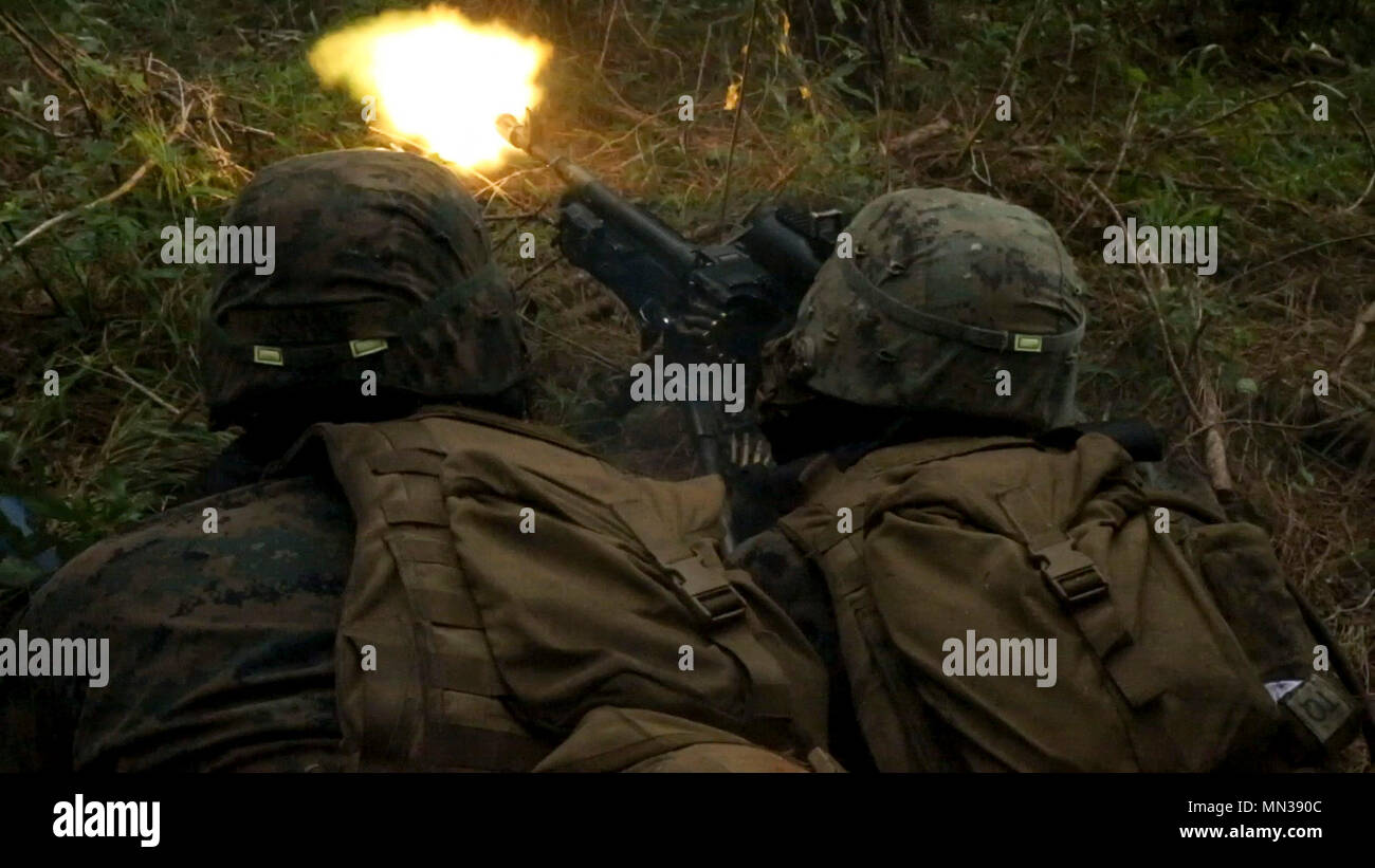 Marines conducting an ambush, use an M240B medium machine gun to fire ...