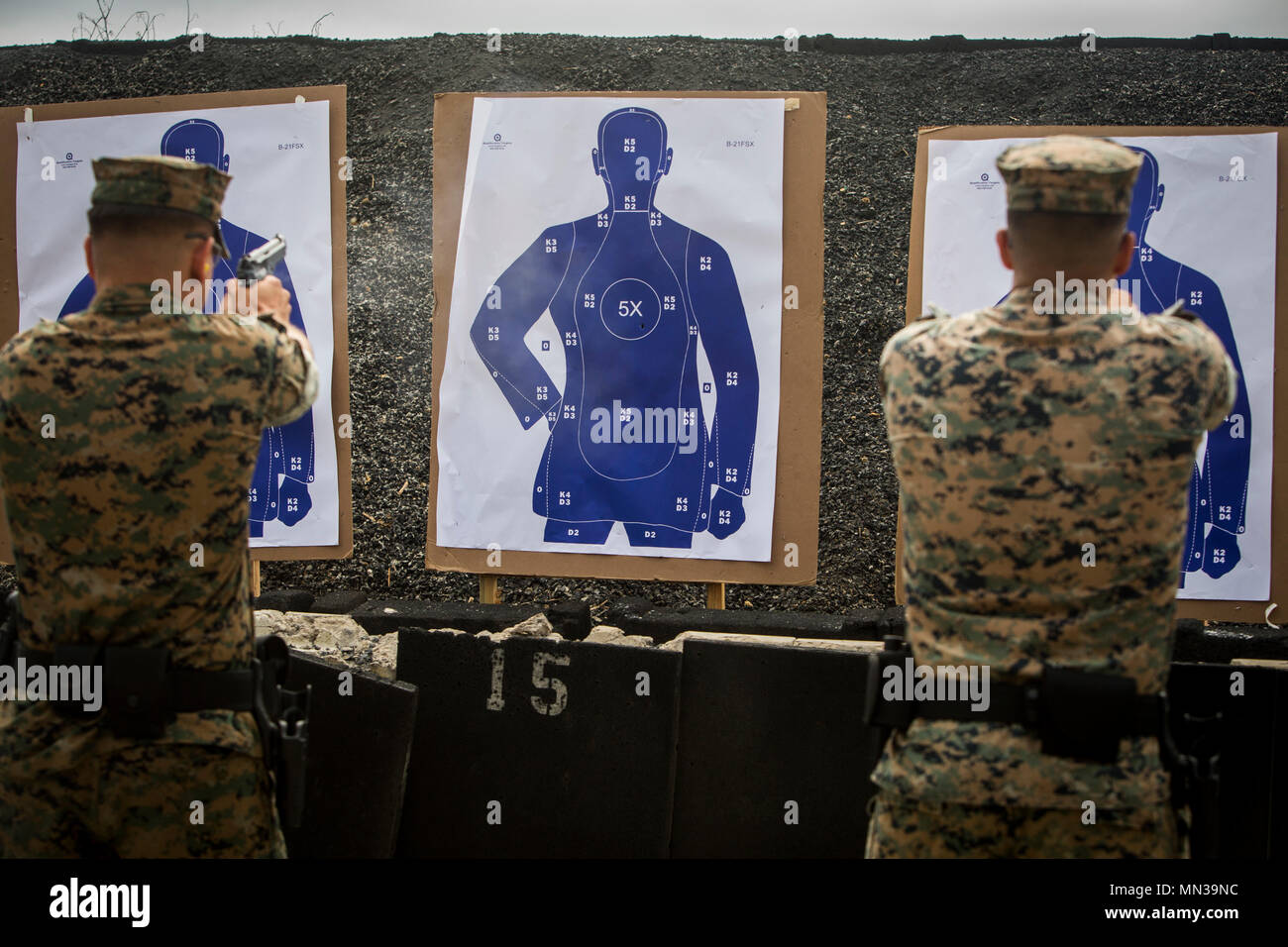 U.S. Marines with the Provost Marshal’s Office, fire at targets during ...