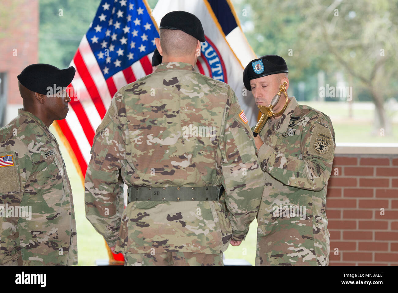 Incoming brigade CSM Ryan Razon hands the battalion sword to SGM James ...