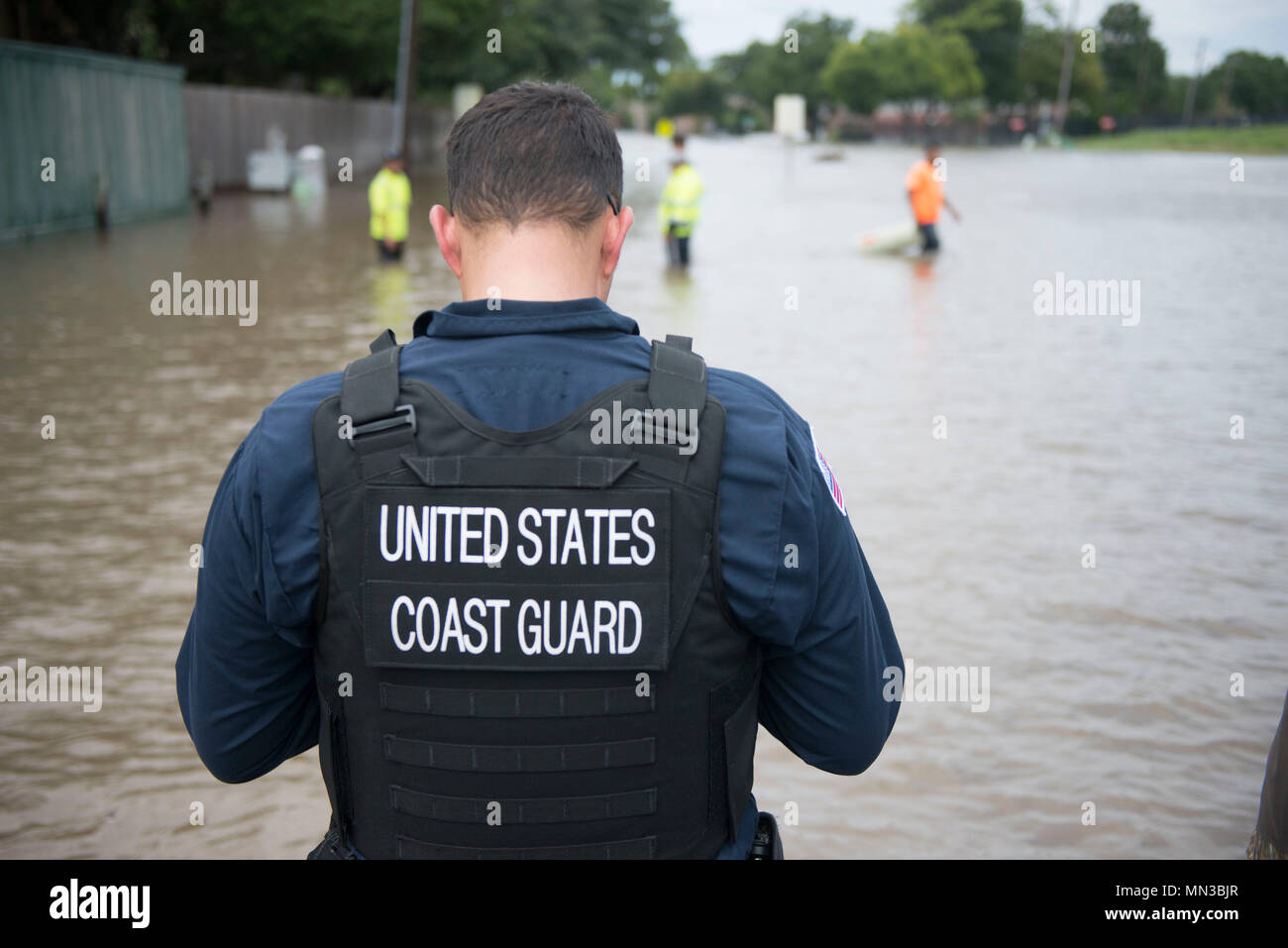 A Coast Guard Maritime Safety and Security Team Houston member assists ...