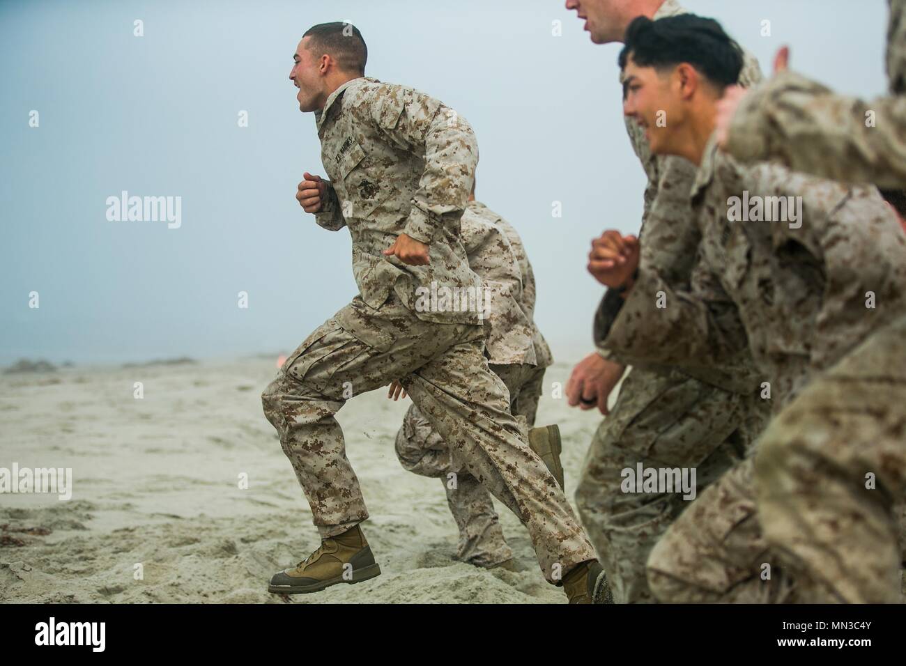 U.S. Marines with 1st Light Armored Reconnaissance Battalion, run a 400-meter sprint towards the ...