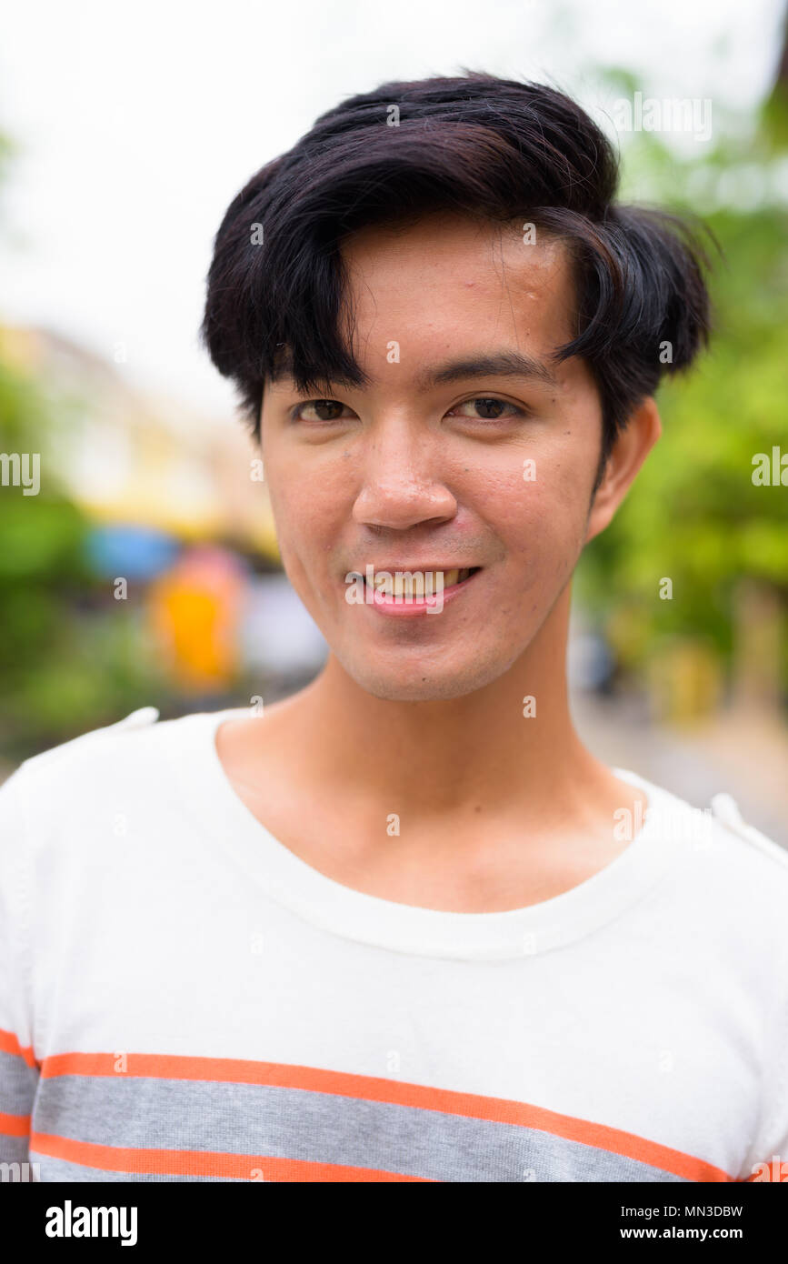 Young handsome Asian man in the streets outdoors Stock Photo - Alamy