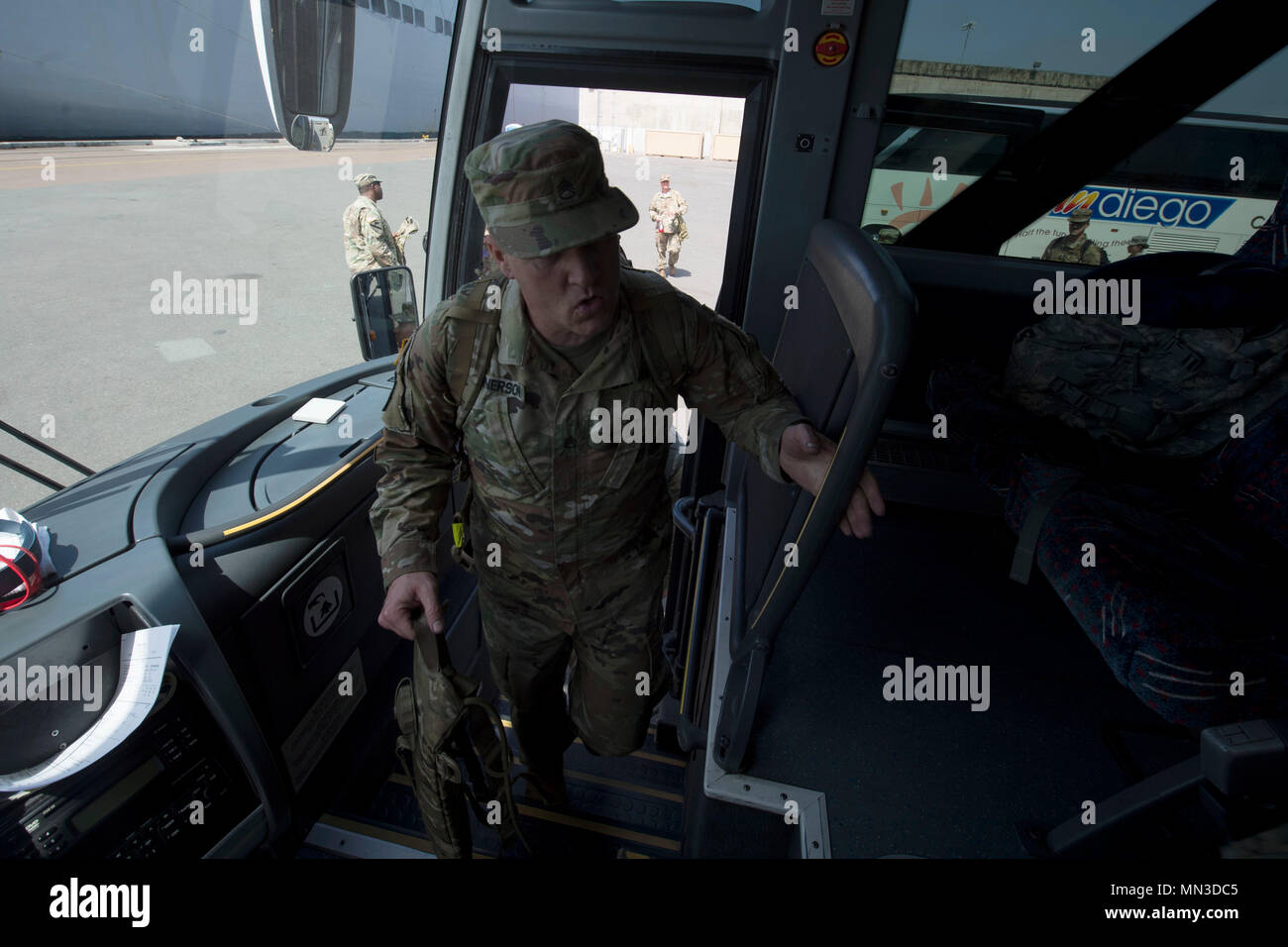 U.S. Army soldiers from various units load up on busesl at the Port of ...