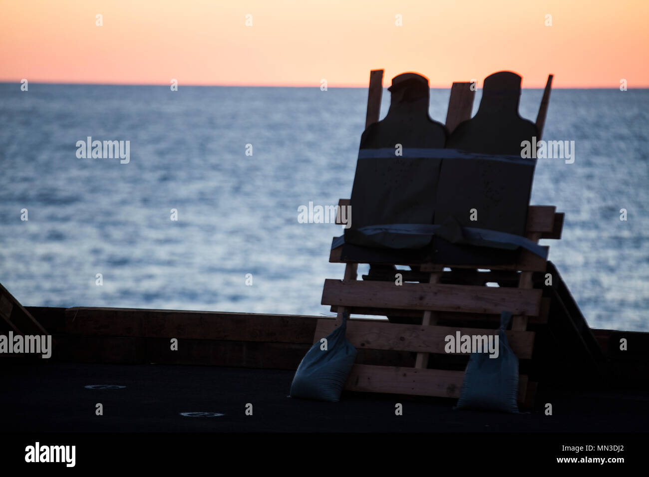 Targets sit propped against a pallet atop an aircraft elevator during ...
