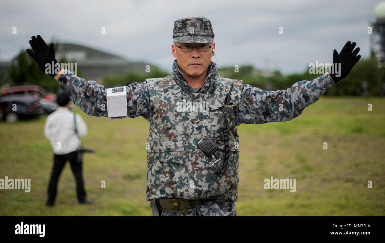 A Japan Air Self-Defense Force 3rd Air Wing security member reinforces ...