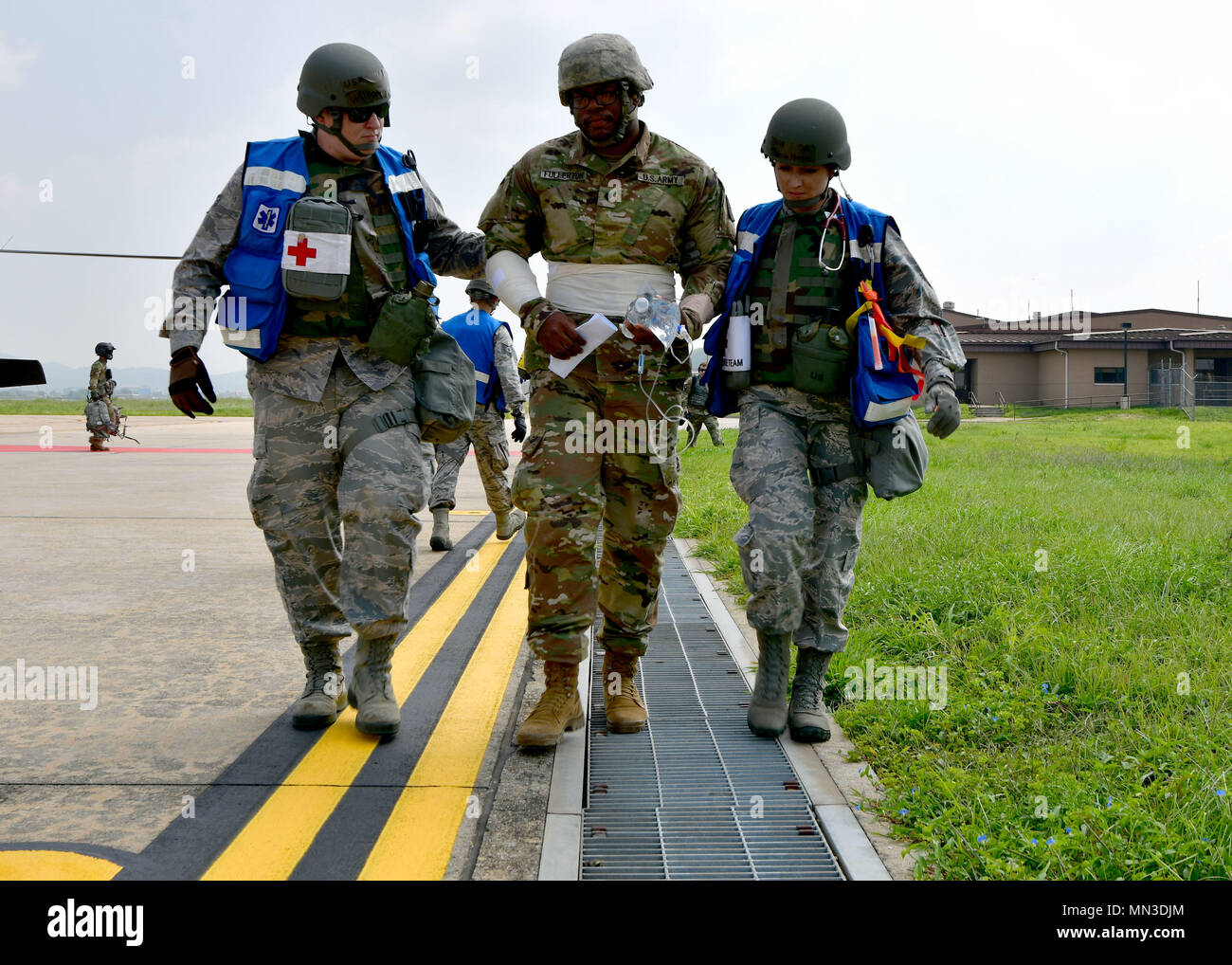 Members from the 51st Medical Group Field Response Team, escort a U.S ...